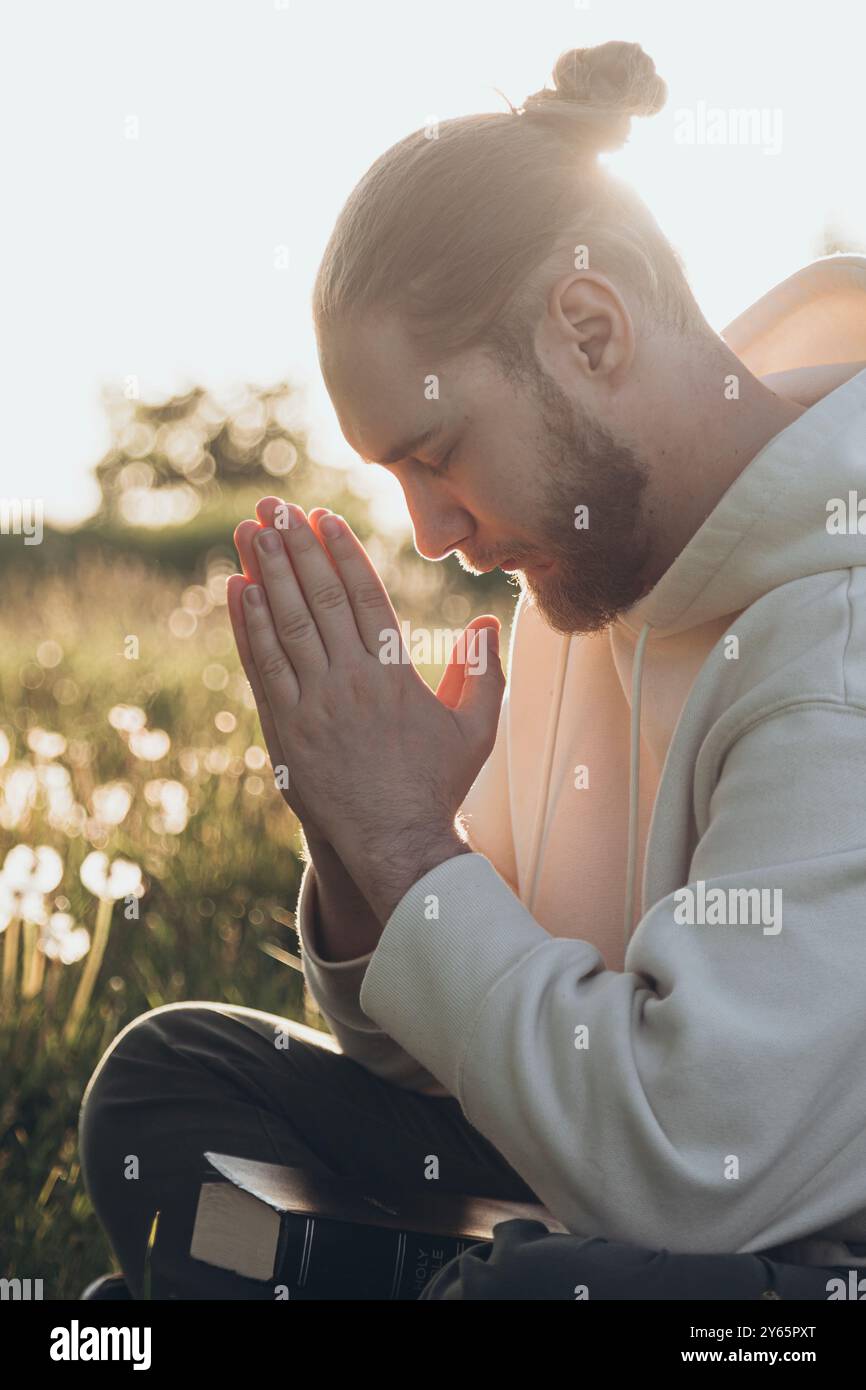 Spiritual moment man praying hands hi-res stock photography and images ...