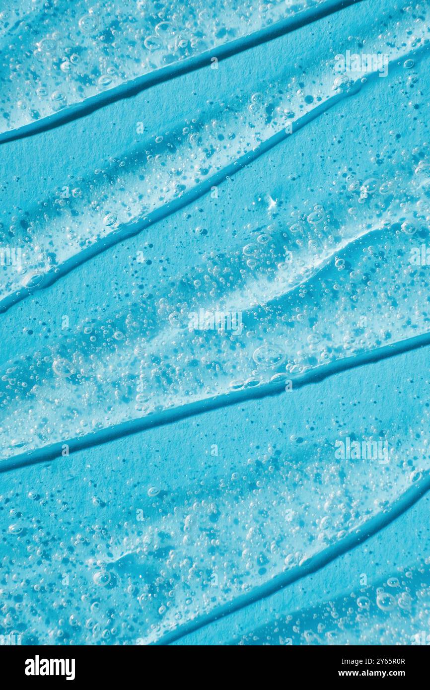 A vibrant close-up image showing the texture of a blue viscous gel with ...