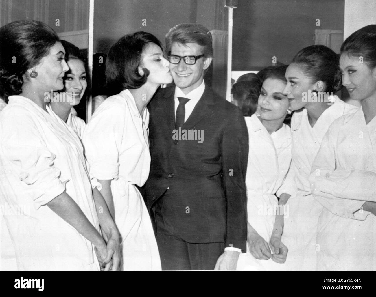 Congratulatory kiss from model Eva for Paris deisgner Yves Saint ...