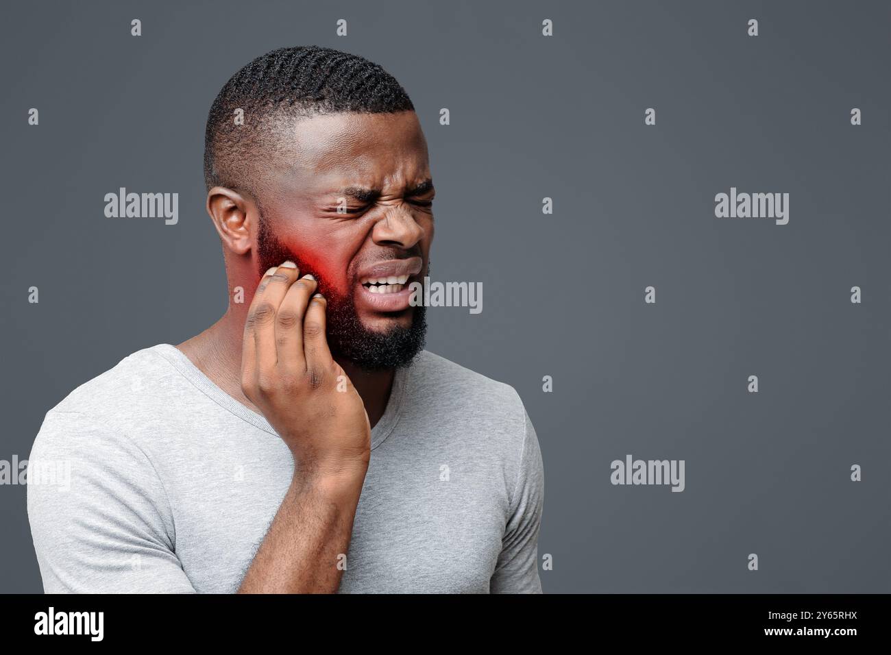Young afro man having wisdom teeth problem Stock Photo - Alamy
