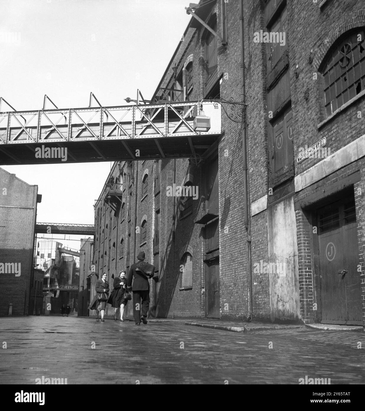 A view down Wapping High Street , East London , lined with wharves and ...