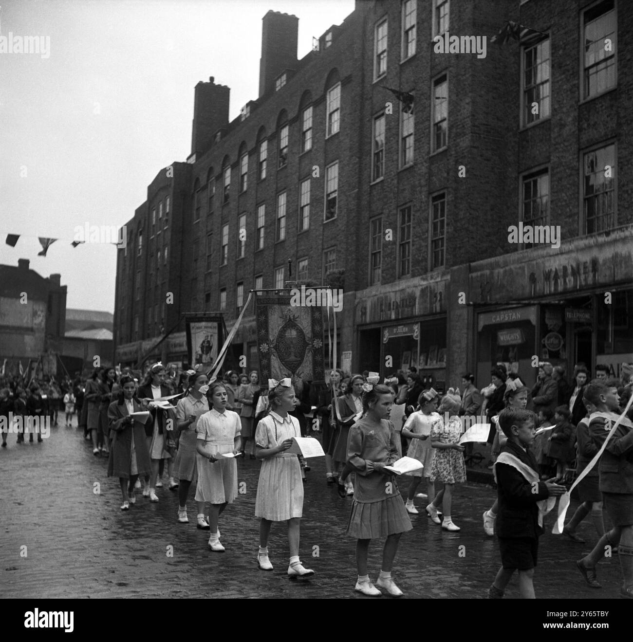 Children processing down Wapping High Street , East London , during the ...