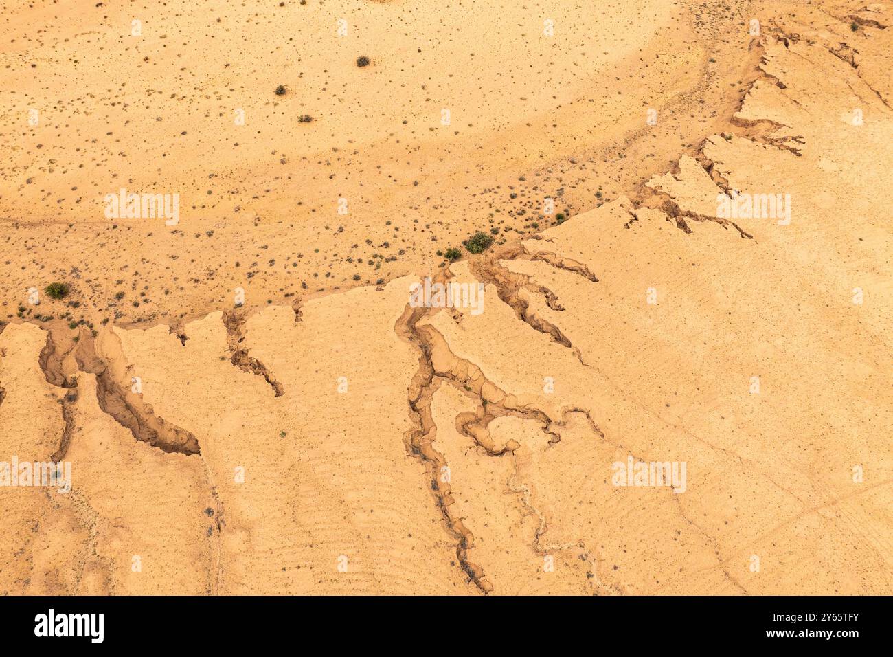 Aerial shot capturing the intricate textures of eroded soil and winding ...