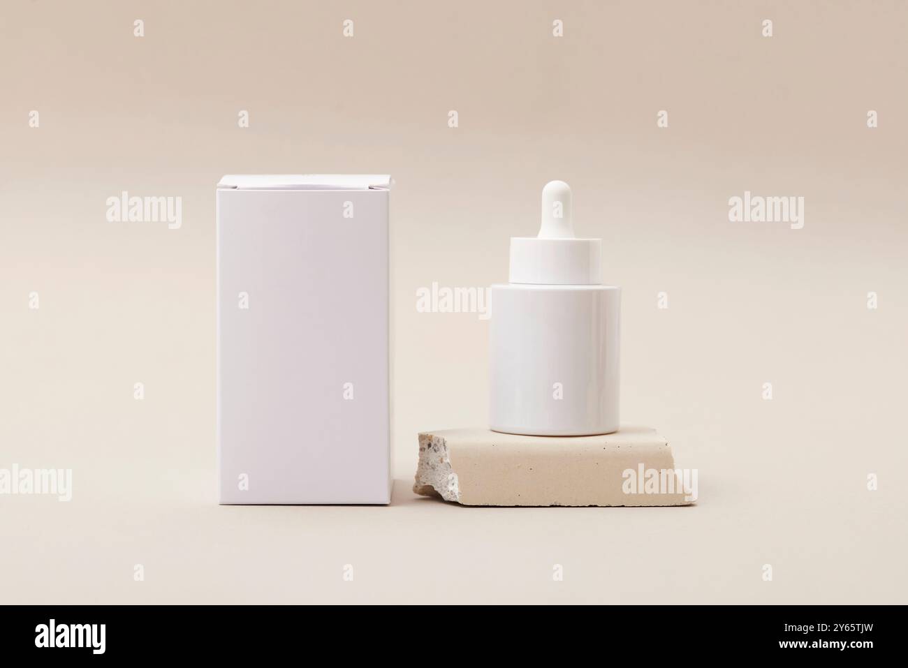 An elegantly presented serum dropper bottle and matching carton resting ...