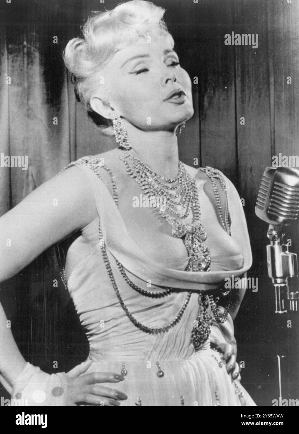 In a revealing pink chiffon dress , reportedly costing six thousand ...