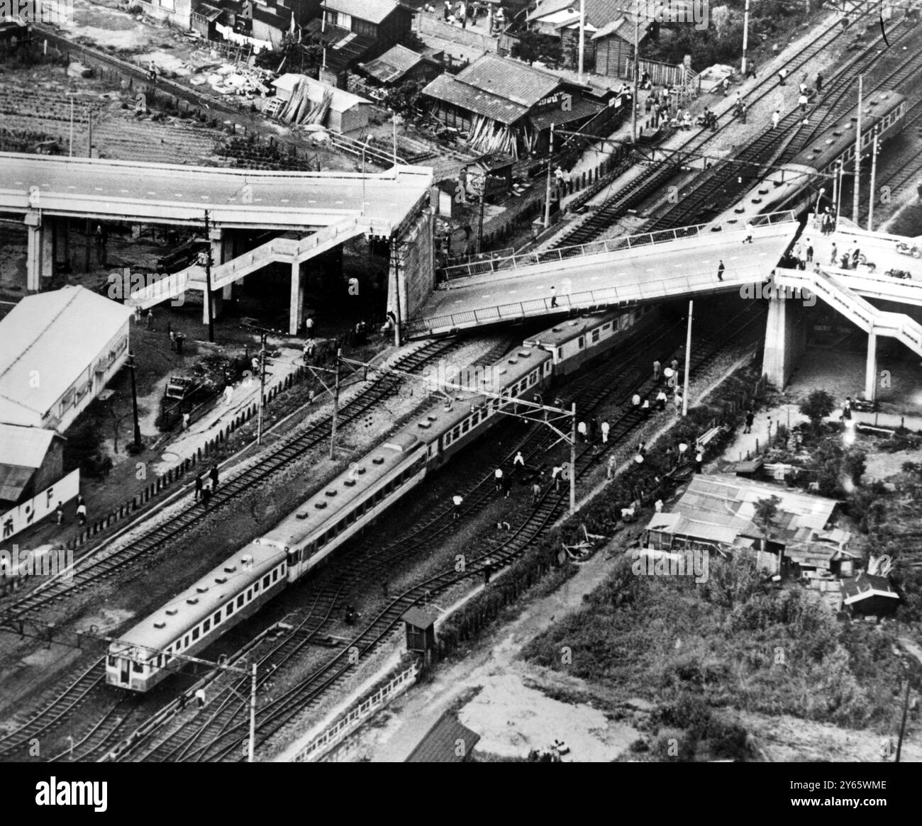 Earthquake A bridge has collapsed on to a train . Tracks are twisted ...