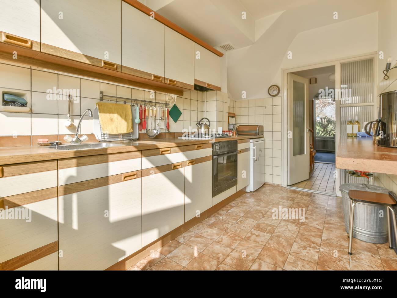 A bright, well-lit kitchen space featuring modern amenities, wooden ...