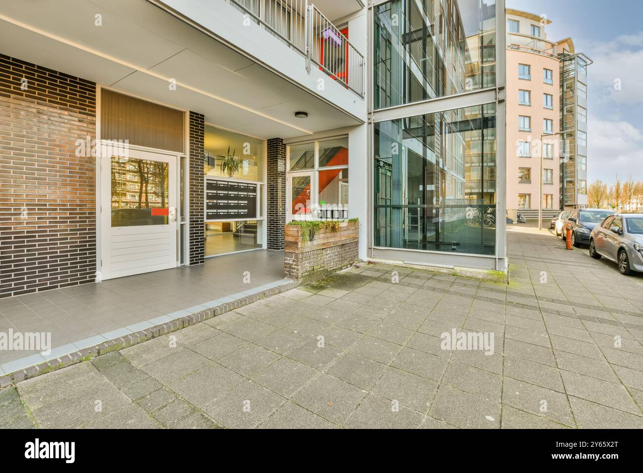 Spacious entrance area to a modern apartment complex featuring a glass ...