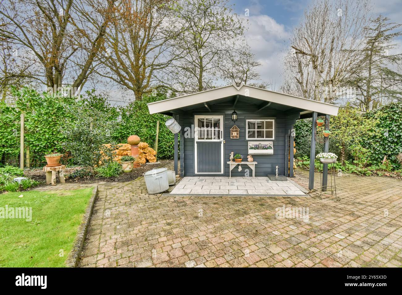 A charming wooden garden shed with a gable roof set within a verdant ...