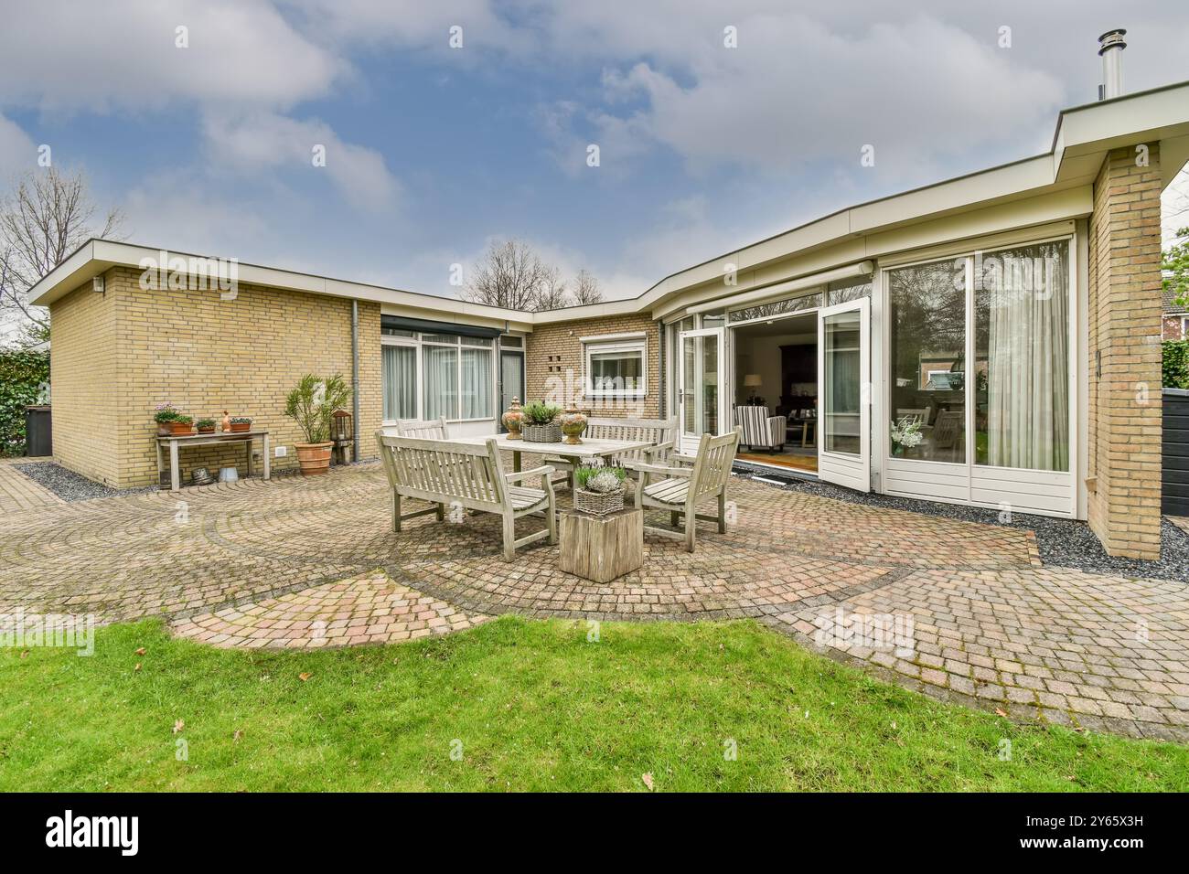 Modern suburban home featuring a spacious patio with outdoor seating ...