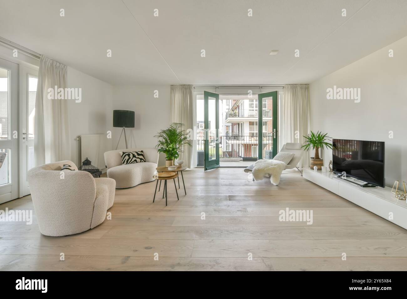 An airy modern living room with natural light, stylish furniture, and ...