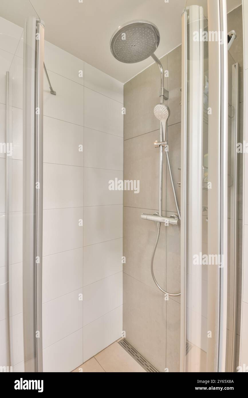 A contemporary corner shower cabin featuring a large overhead ...
