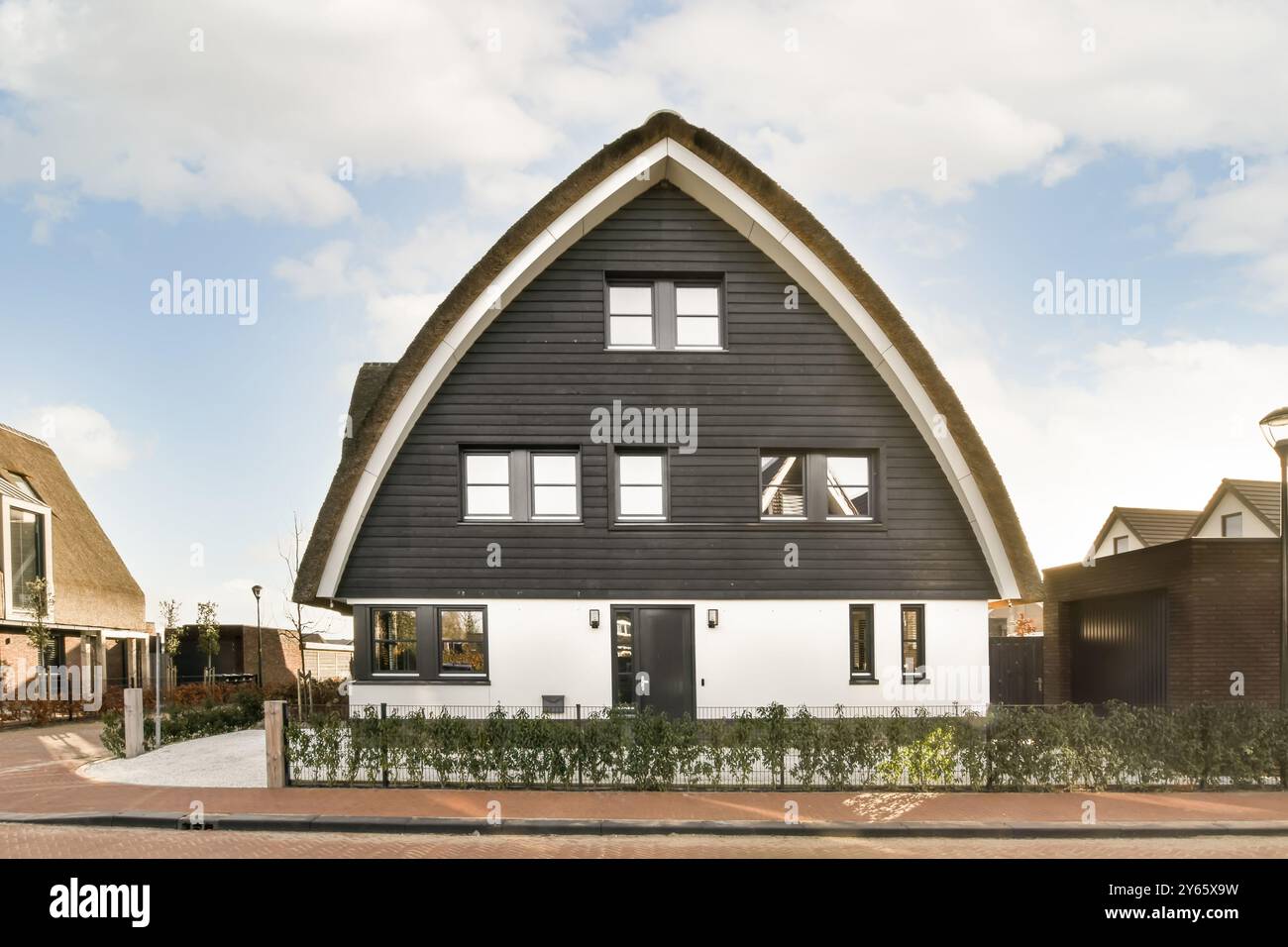 A contemporary house featuring a striking two-tone color scheme with a ...