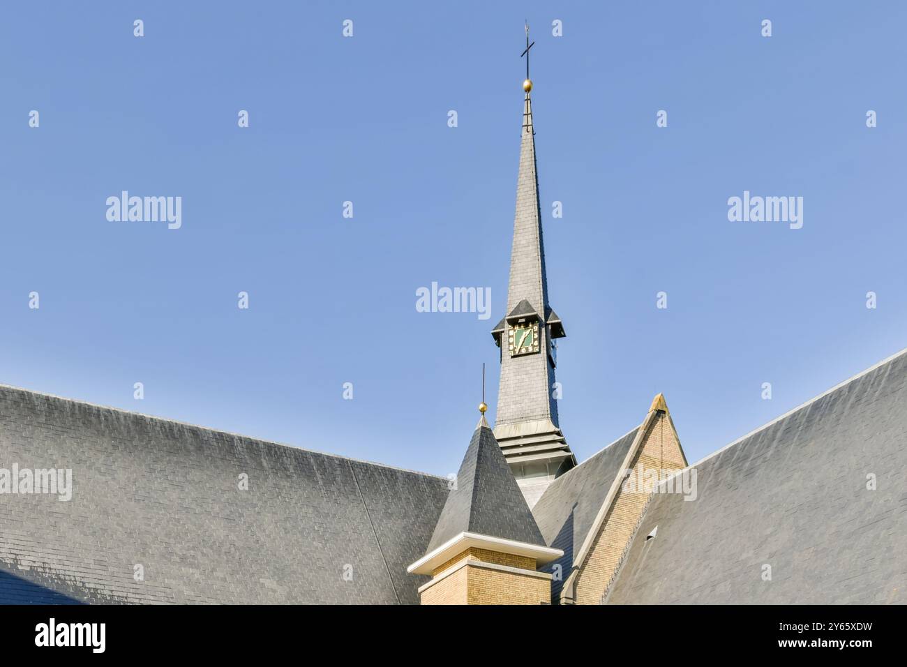 Elegant church spire with a backdrop of a clear blue sky, showcasing ...