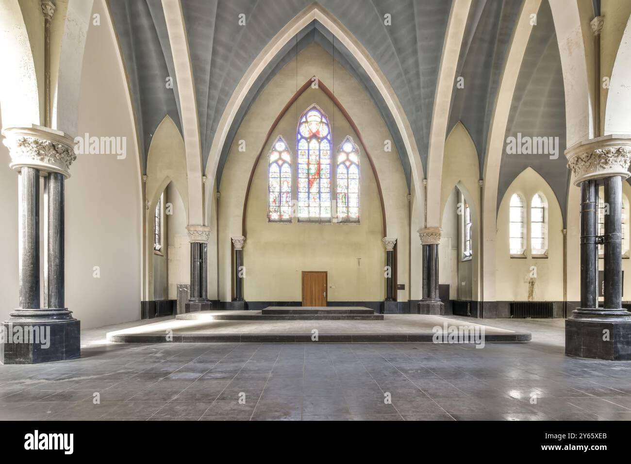 The photo captures the vast interior of a Gothic church, highlighting ...