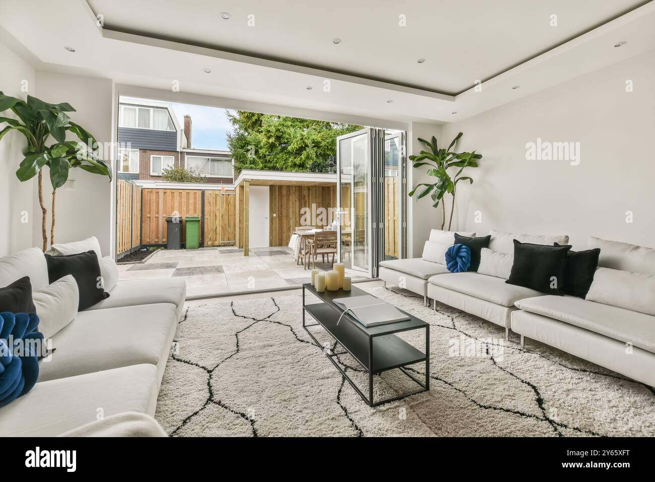 Modern living room that seamlessly connects to a cozy patio area ...