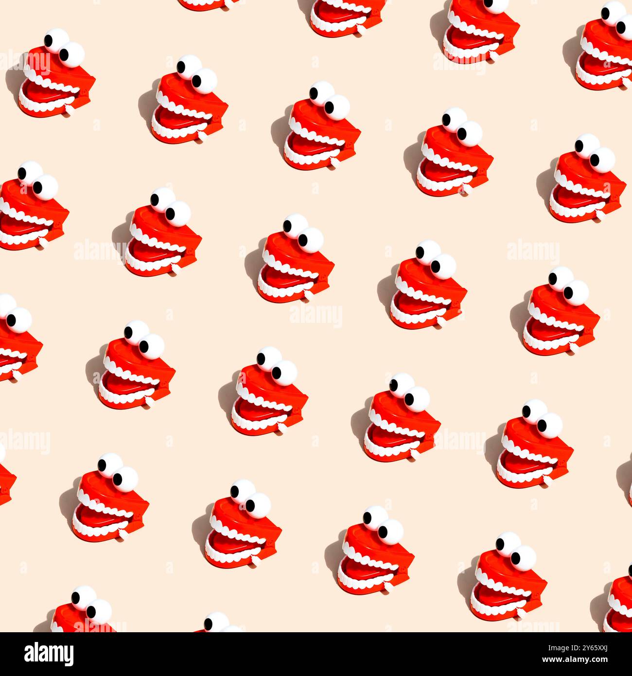 A whimsical pattern of red and white chattering teeth toys scattered on ...
