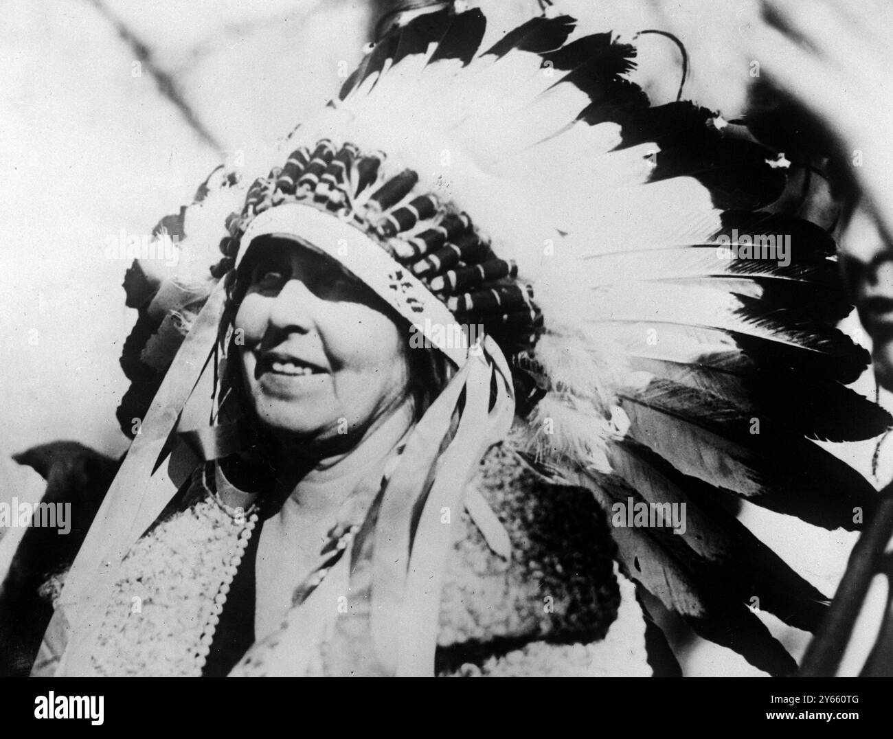 Queen Marie of Rumania wearing the war bonnet presented by a Sioux ...
