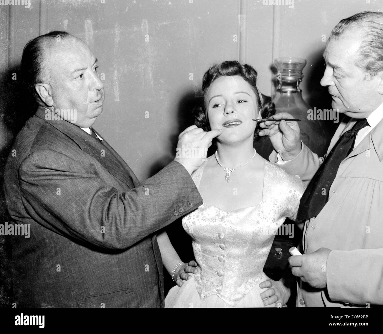 Alfred Hitchcock with his daughter Patricia while she is being made up ...