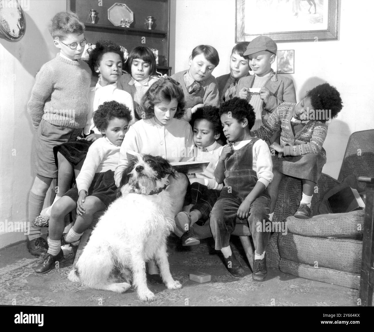 One Happy Family Sixteen year old Anna Collis reads a bed time story to ...