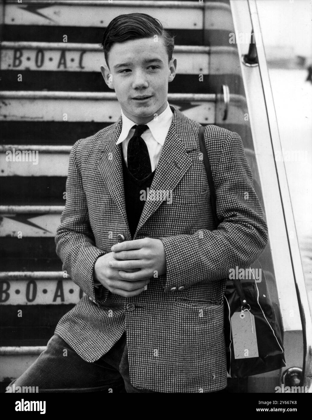 Lord Angus Montagu , 14 , boarding a BOAC plane at London Airport for ...