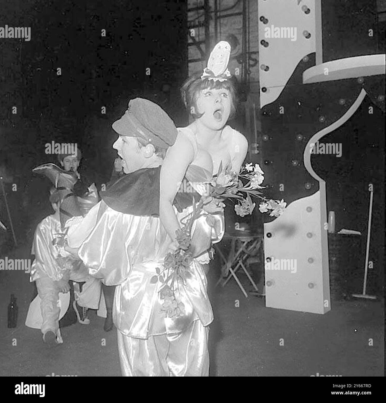 British Tommy clad in pierrot costume , actor Larry Dann holds ...