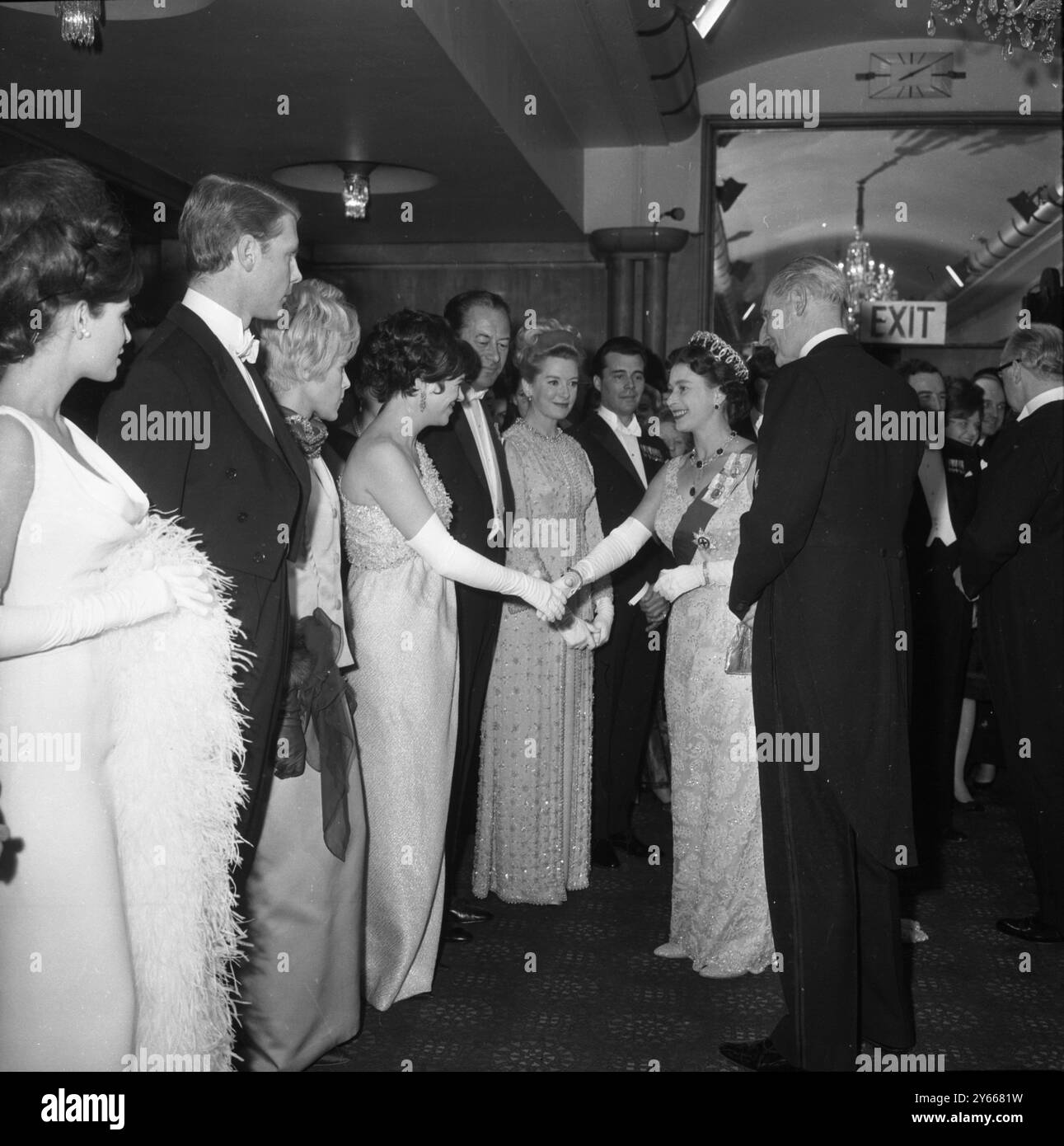 Queen Elizabeth II shakes hands with Rachel Roberts, standing next to ...