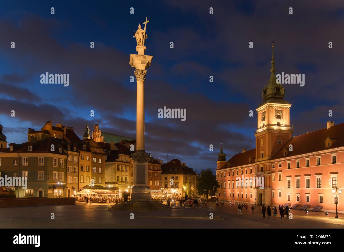 The charming old town of Warsaw glows softly as dusk settles ...