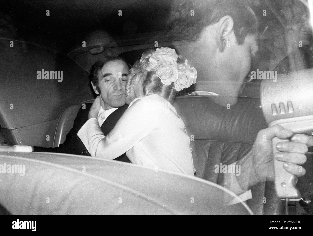 Popular French singing star Charles Aznavour , 43 , receives a kiss ...