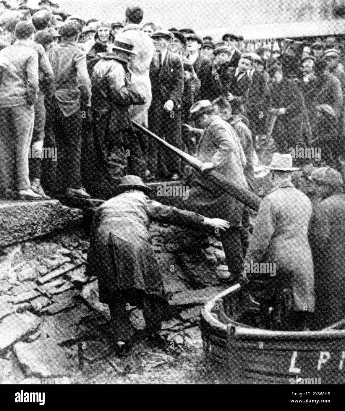 Miss Amelia Earhart ( in flying cap , facing camera , amid the crowd on ...