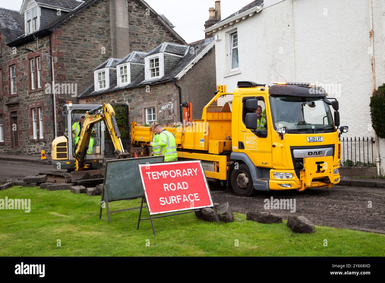 Workmen repairing road surface, Rhu, Scotland showing truck, and small ...