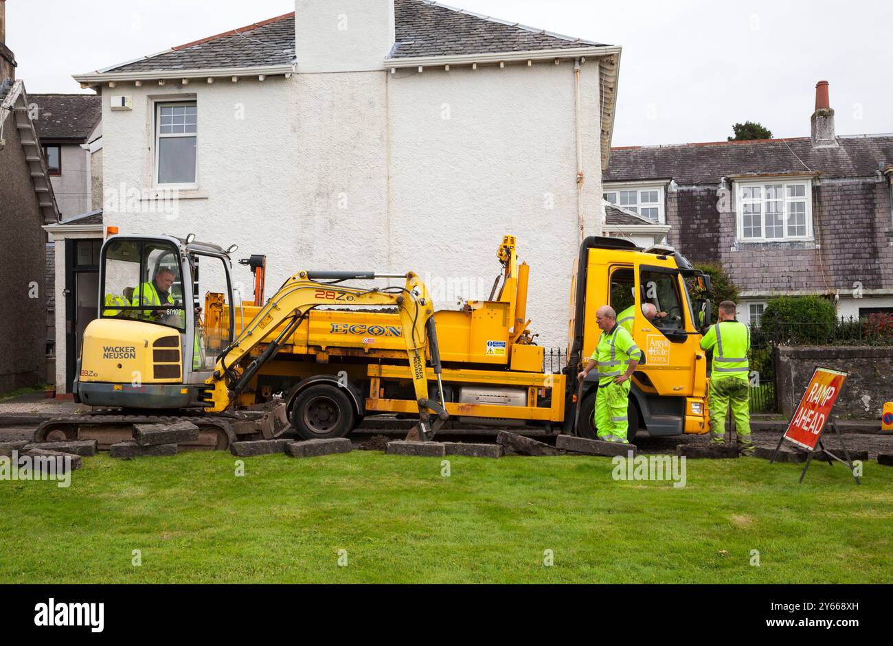 Workmen repairing road surface, Rhu, Scotland showing truck, and small ...