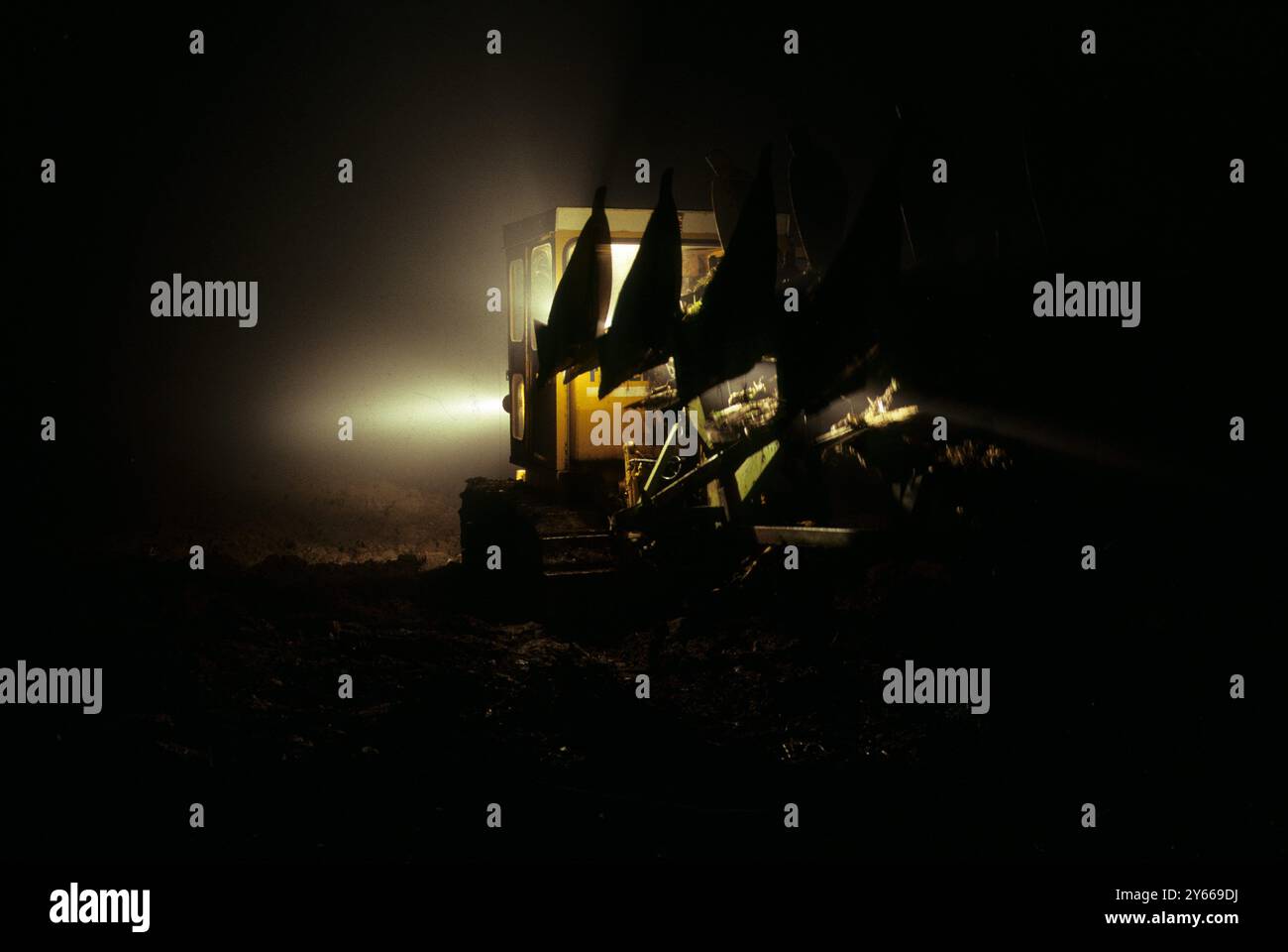 Winter : Ploughing in sticky conditions in fog at night , Lincolnshire ...