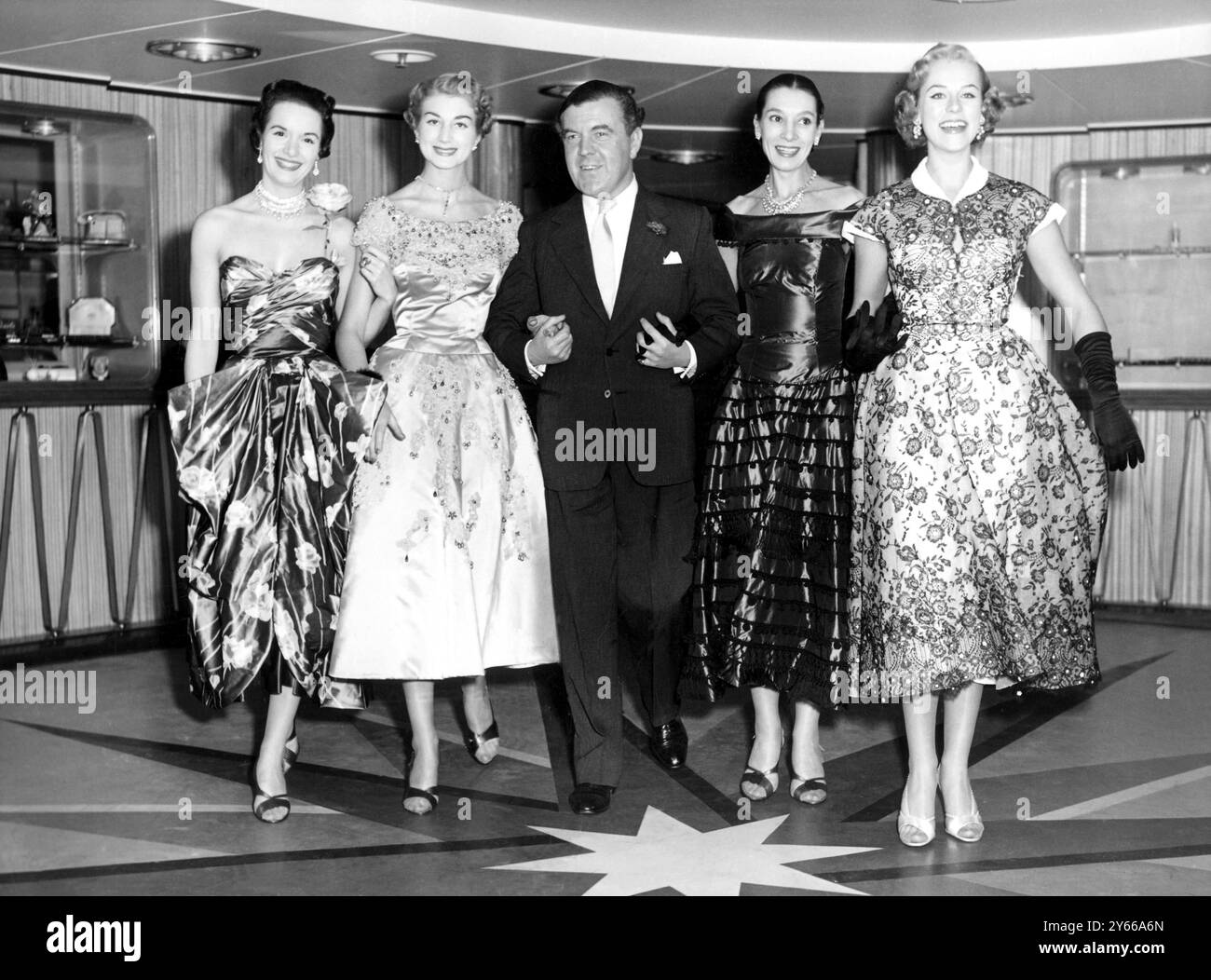 Norman Hartnell hosting his own show of lavish evening gowns in 1953 ...