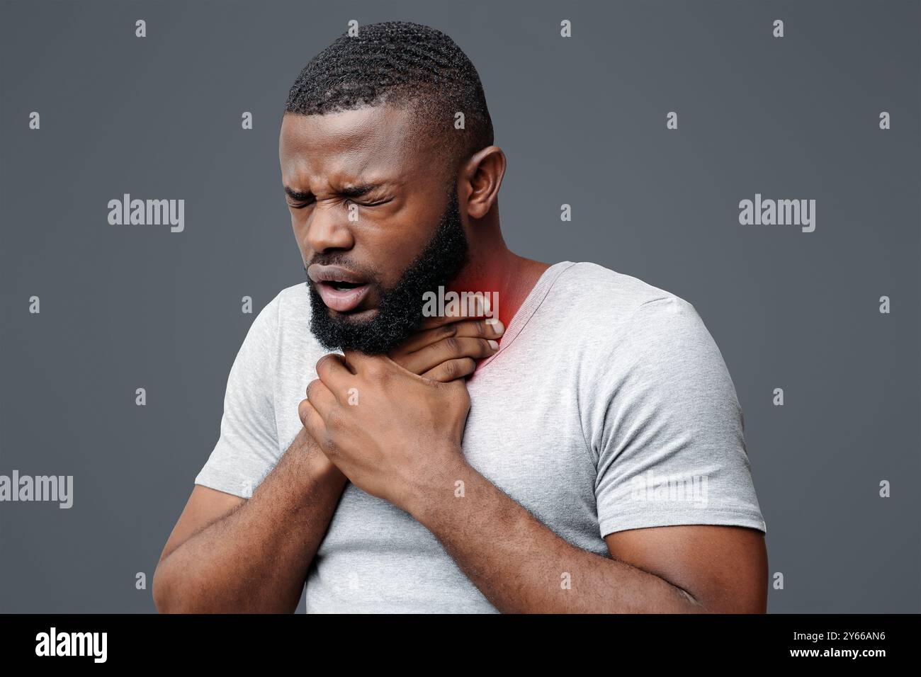 Unhealthy black guy touching neck and coughing Stock Photo - Alamy