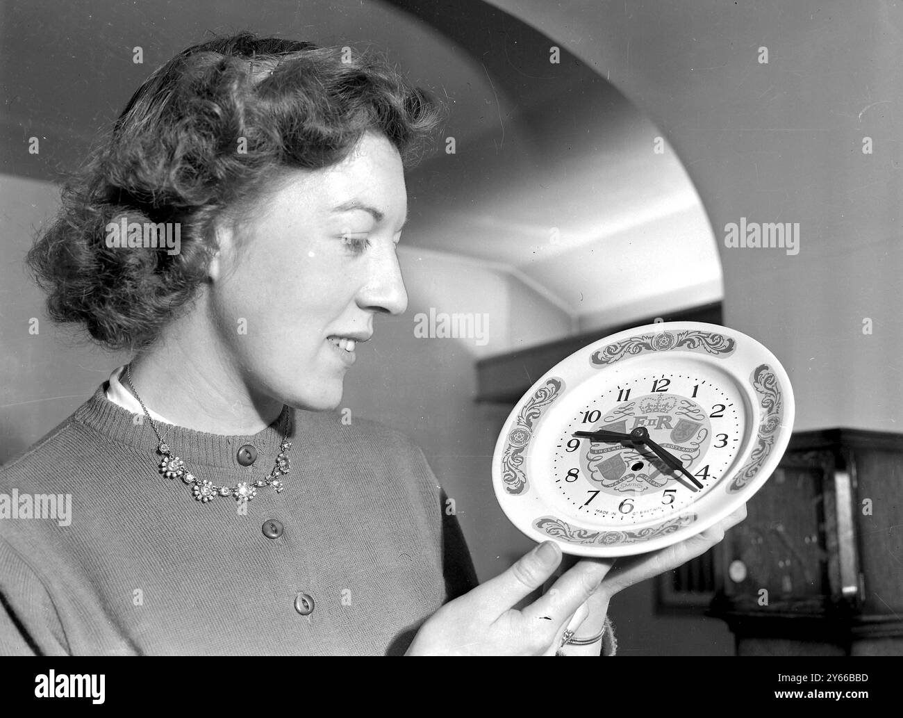 London: Miss Doris Flon, of Edgware, Middlesex, with Wall clock ...