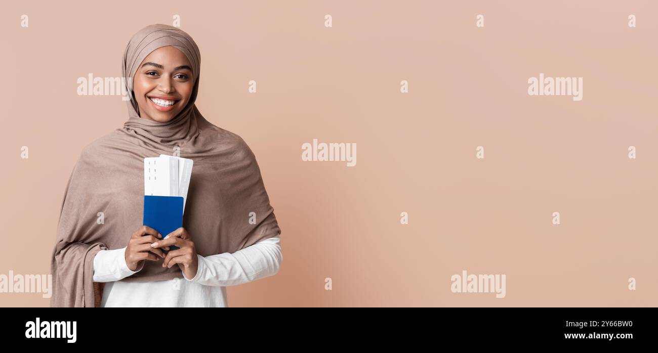 Happy afro muslim woman in hijab with passport and tickets Stock Photo ...