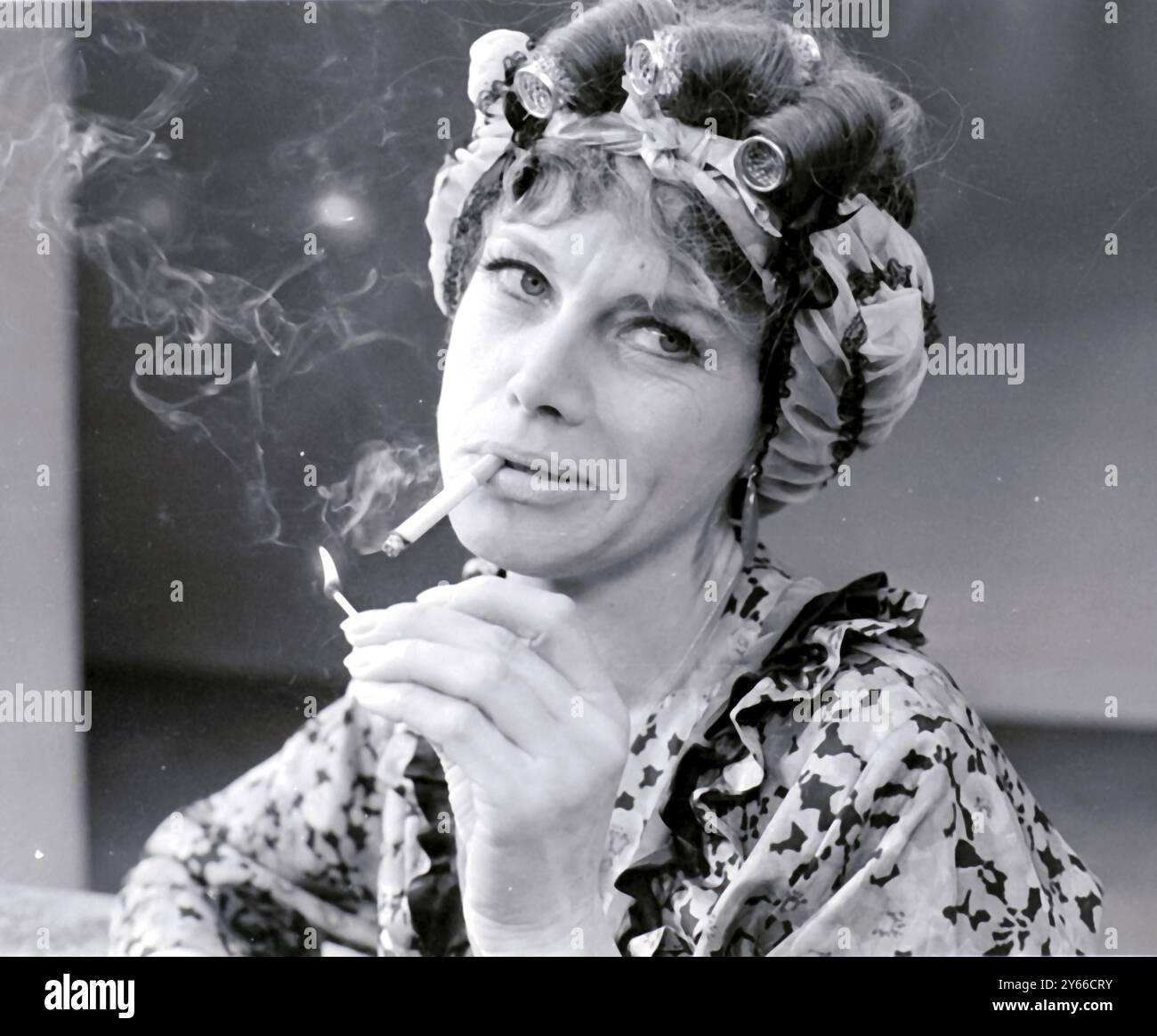 Hair in curlers and with drooping cigarette in mouth is Honor Blackman ...