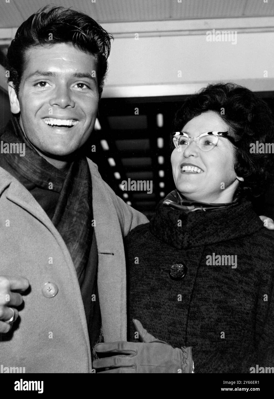 Cliff Richard greets his mother Mrs Webb with a kiss as she met him at ...
