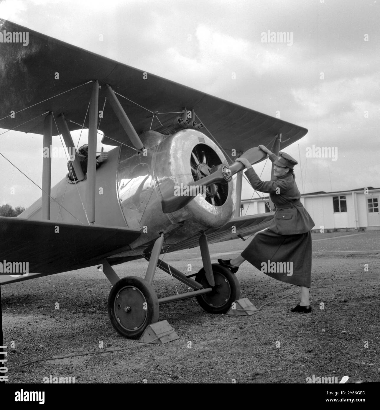 Swinging the propeller of a Sopwith Camel Plane is Irene Griffiths ...