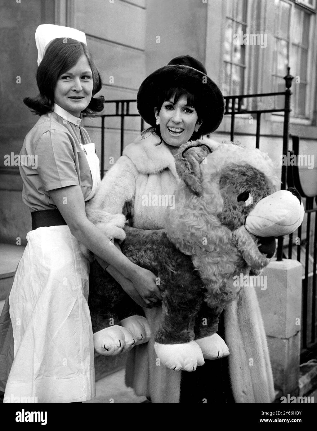 With a huge lion mascot in her arms, singer Alma Cogan today (Saturday ...
