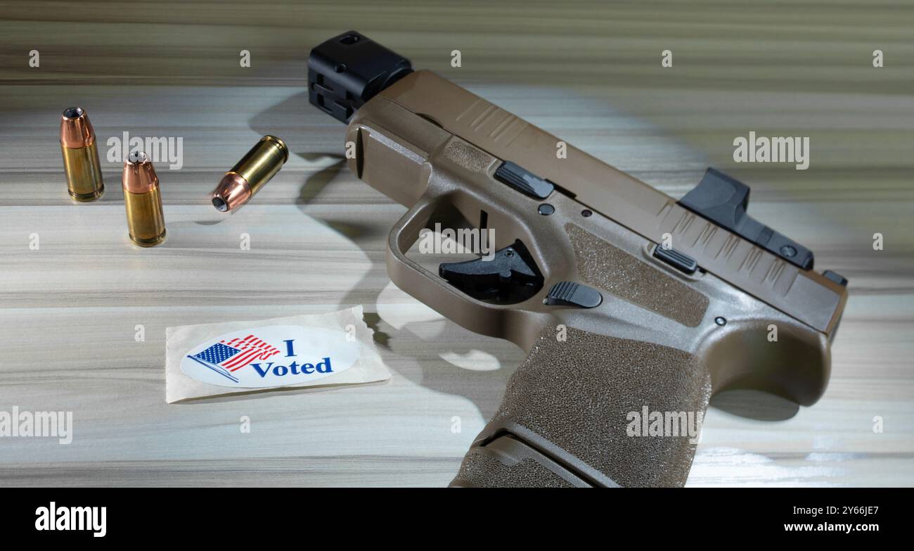 9 mm semi-automatic handgun with ammunition on a table with an I voted ...