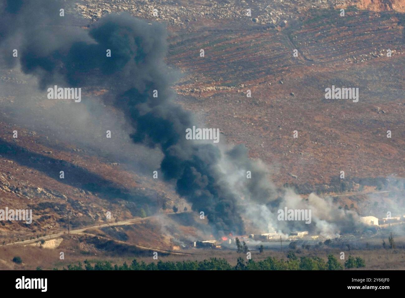 Flame and smoke rise from an Israeli airstrike in the Khiam valley, as ...