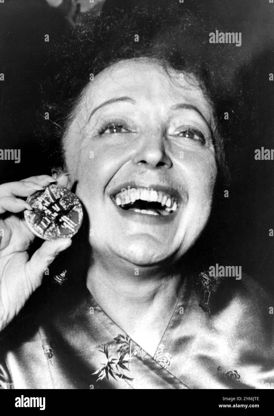 Edith Piaf with her gold emblem award for interpretation of the song ...