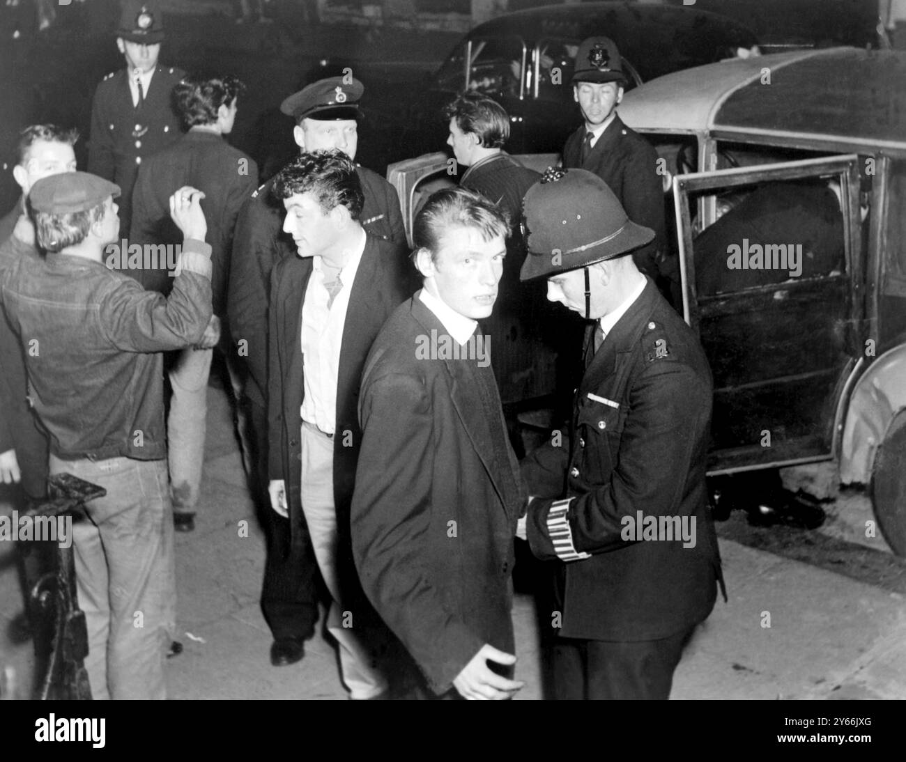 Police search a teenager during the race riots in Notting Hill, London ...
