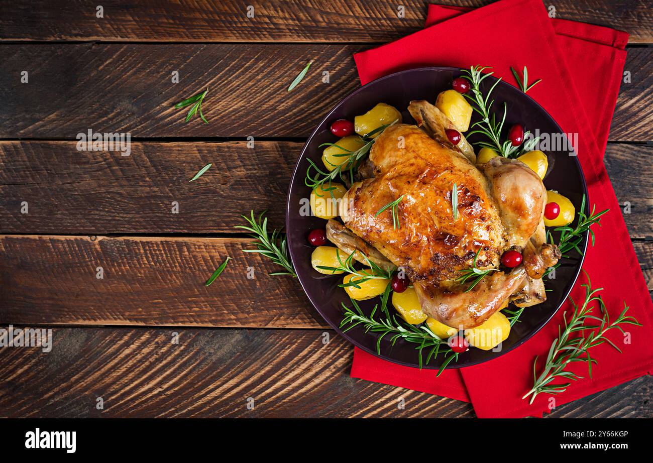 Baked chicken or baked turkey. The Christmas table is served with a ...