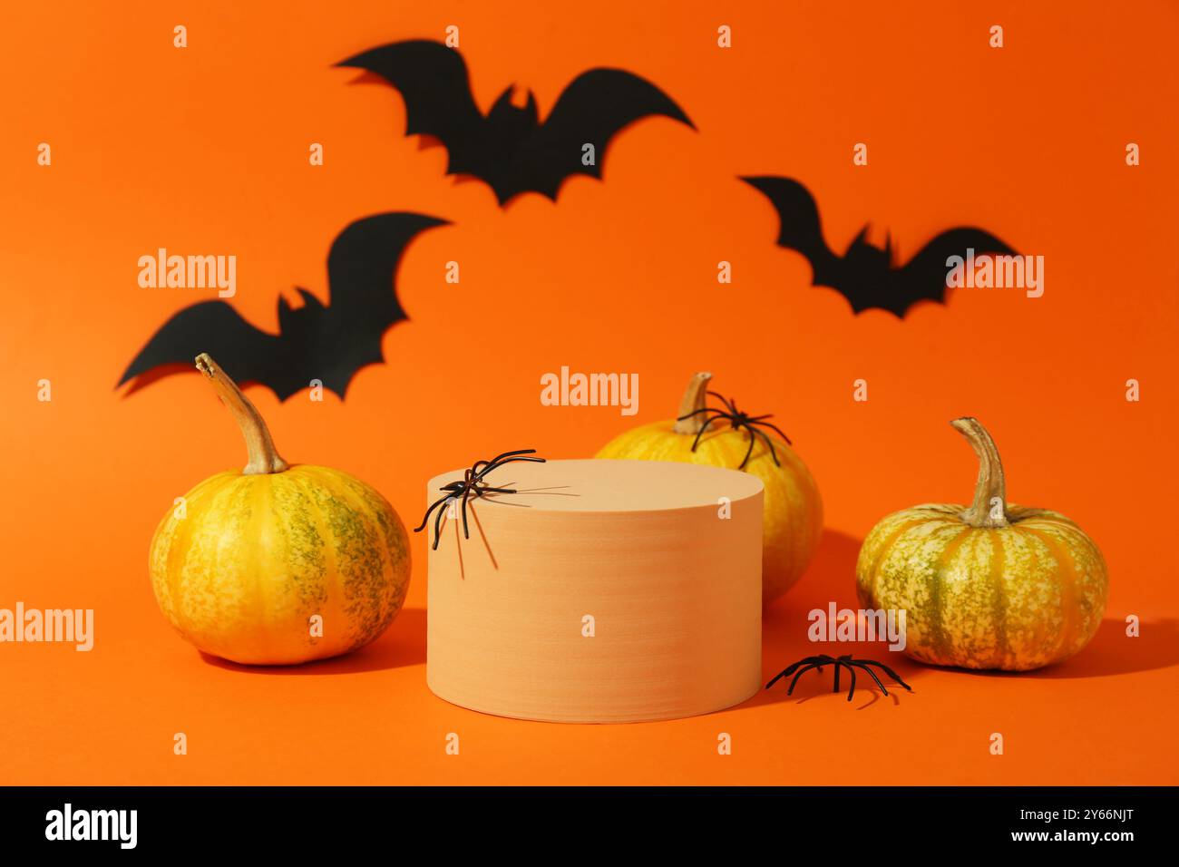 Halloween celebration. Black paper bats, spiders pumpkins and podium on ...