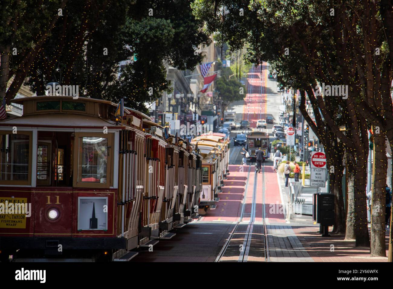 The image shows a classic street scene featuring a line of iconic San ...