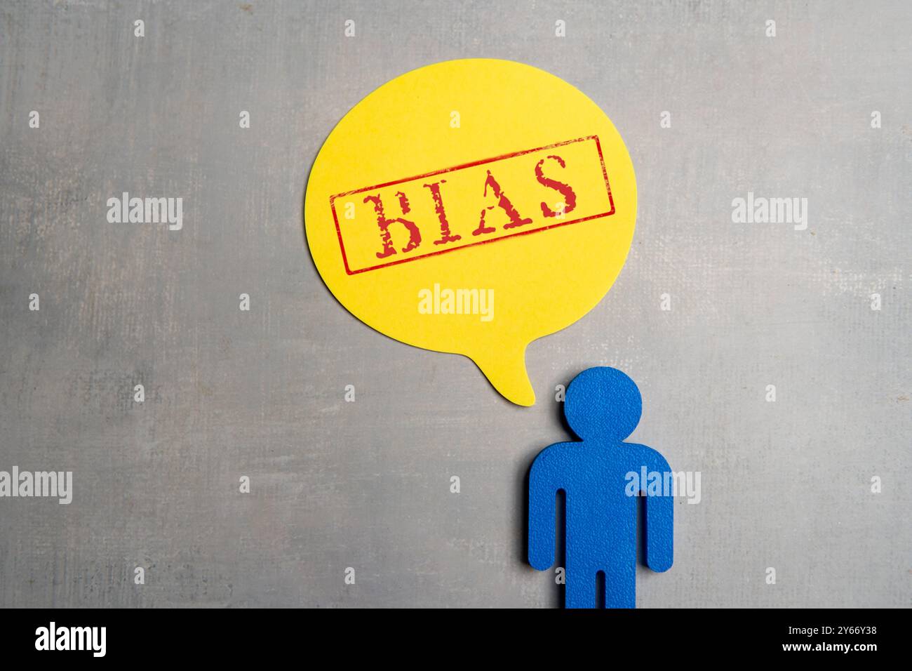Blue figurine and a yellow speech bubble with red stamped word “BIAS ...