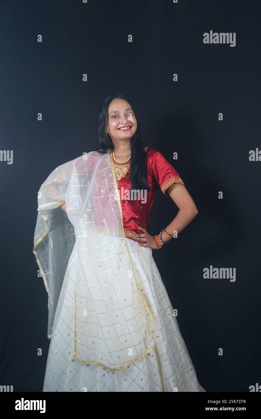 A young Indian individual stands confidently, poised to engage in the ...